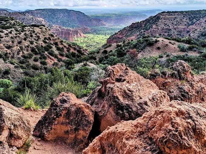 Red rock boulders tumble toward a lush canyon floor at Caprock Canyons, where the Panhandle keeps its best secret.