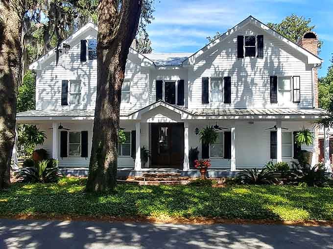 Spanish moss drapes over a classic white Darien home like nature's own curtain call, graceful and completely unhurried.