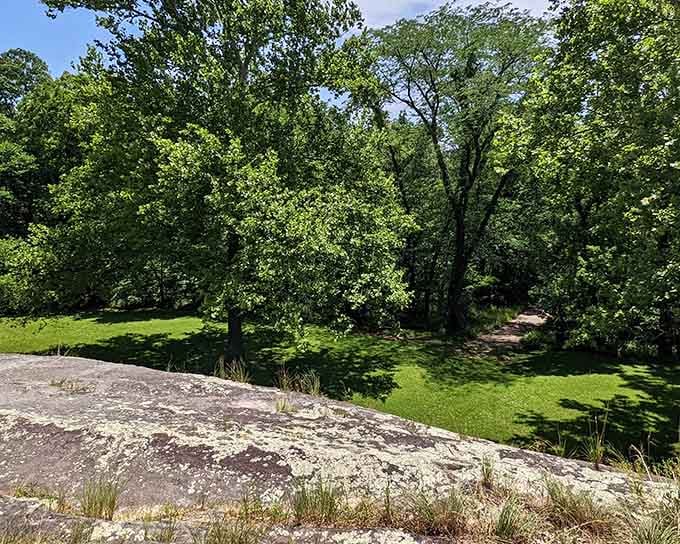 Lichen-covered granite catches the summer sun at Graham Cave Loop, where the rock shelf ahead holds thousands of years of stories.