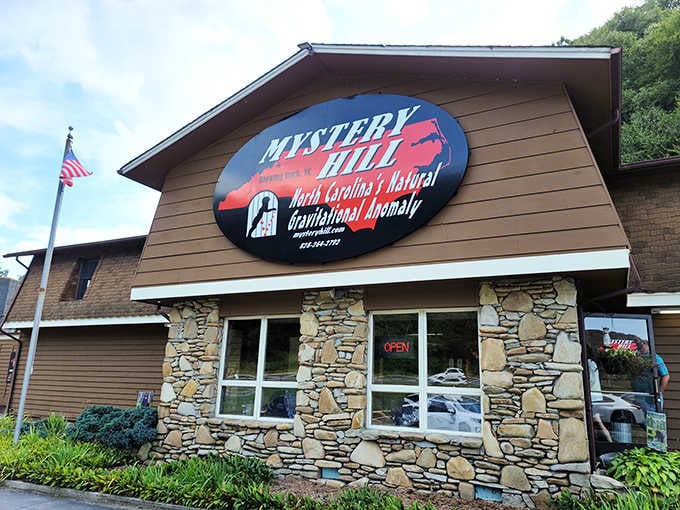 The bold Mystery Hill sign proudly announces North Carolina's Natural Gravitational Anomaly, daring every curious passerby to step inside.