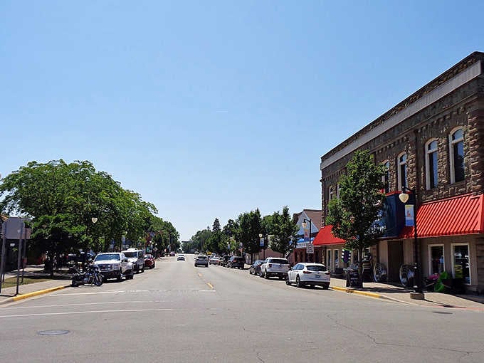 Port Austin's broad main street basks in summer sunshine, its mix of local shops and stone-faced buildings giving the whole block a quietly confident charm.