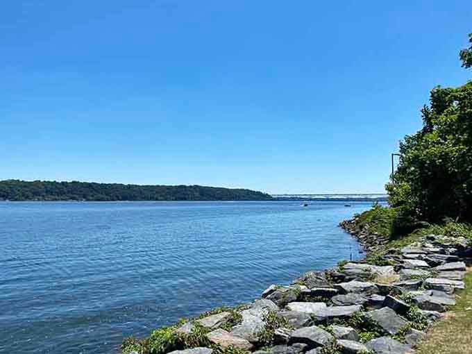The wide Susquehanna River shimmers brilliant blue under a cloudless summer sky, with a distant bridge reminding you civilization is still nearby.