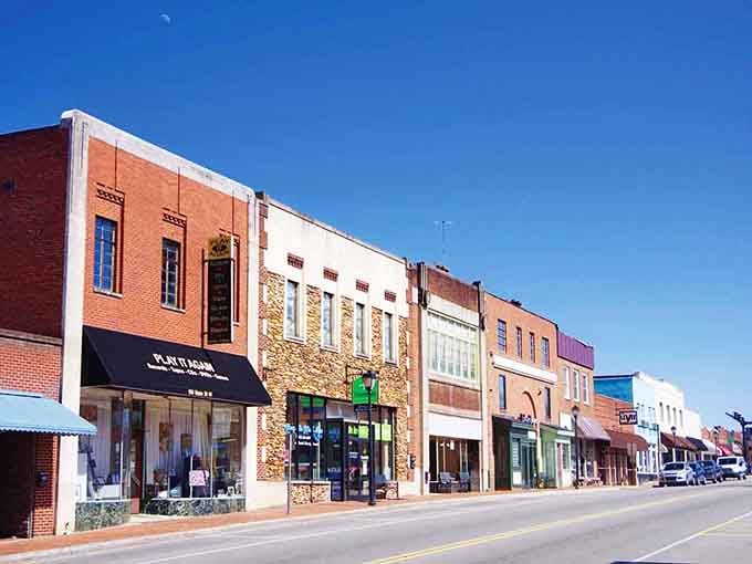Valdese's sunny Main Street mixes brick, stone, and glass storefronts under a deep blue sky that feels almost too perfect.