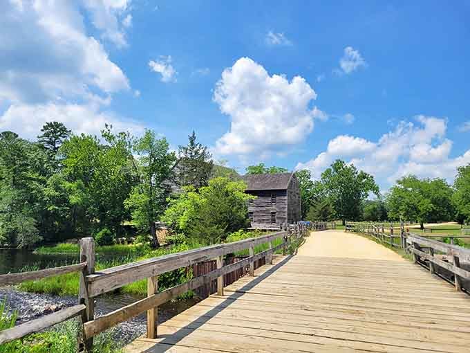 The wooden boardwalk leads to a rustic mill building, creating a scene that Thoreau himself would've appreciated.