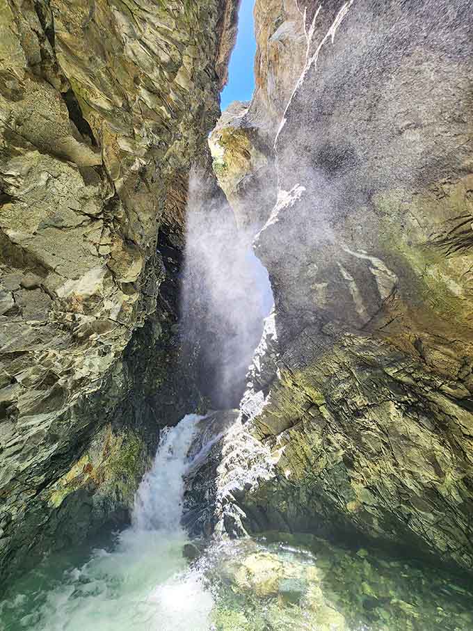 Zapata Falls squeezes through a narrow rock slot and explodes into mist, turning a short canyon walk into a full sensory experience.