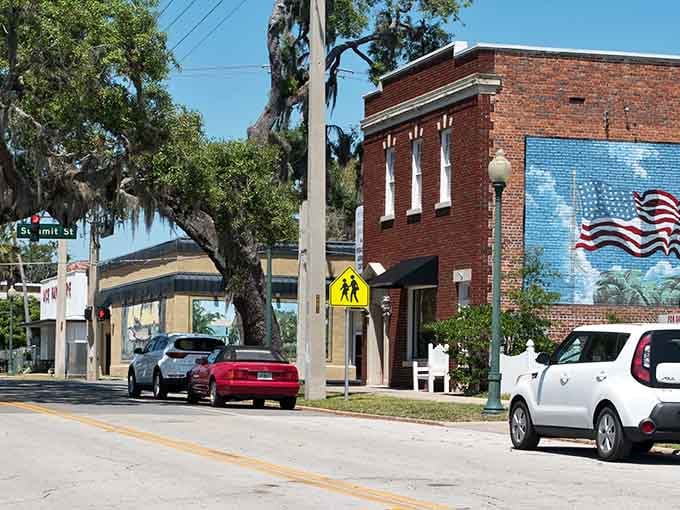 A red brick storefront draped in Spanish moss and a bold American flag mural — Crescent City wears its heart on its wall.