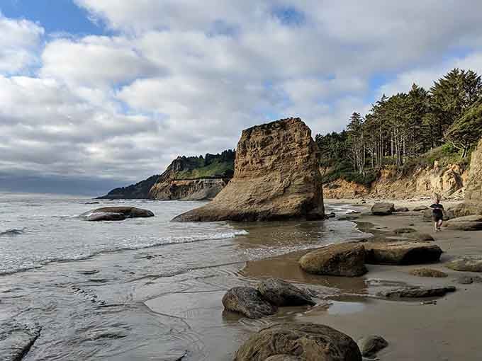 That lone sandstone sea stack rising from the churning tide pools is the Oregon coast's way of reminding you who's really in charge.
