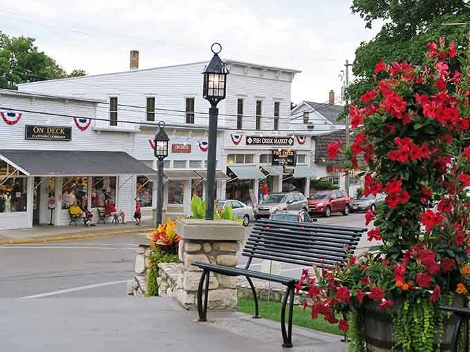 Red petunias, glowing lamp posts, and patriotic bunting make Fish Creek's streetscape look like it was styled for a movie set.