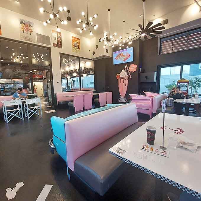 Pink booths, a towering milkshake sculpture, and Sputnik light fixtures at Frisco's create a dining room that feels like the 1950s got a very stylish makeover.