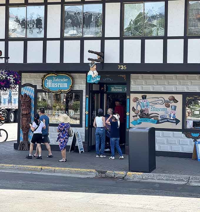 Curious visitors cluster at the museum's doorway on a sunny Leavenworth afternoon, drawn in by colorful signage promising thousands of nutcrackers and zero disappointments.