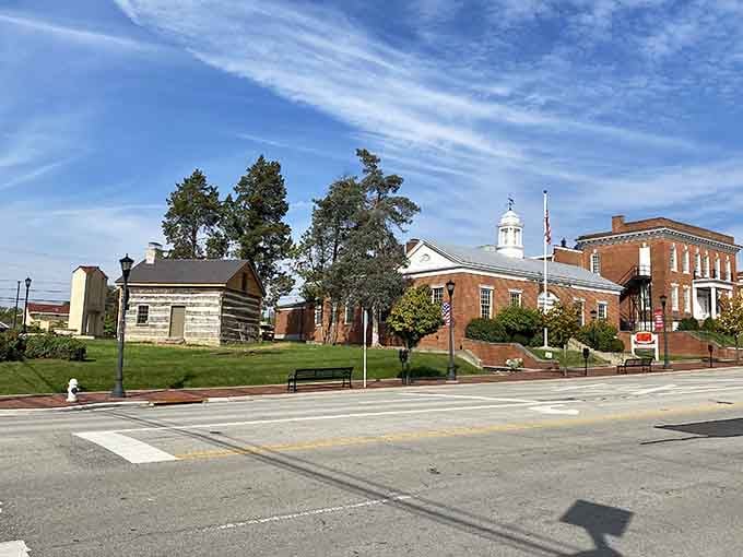 A log cabin and a stately courthouse share the same Lebanon lawn, quietly spanning centuries without making a fuss about it.