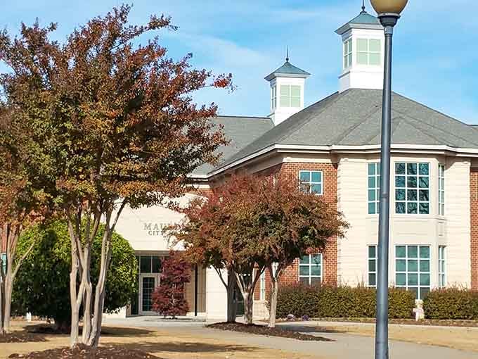 Mauldin City Hall stands proud beneath autumn trees, a welcoming landmark that says this town means serious, well-organized business.