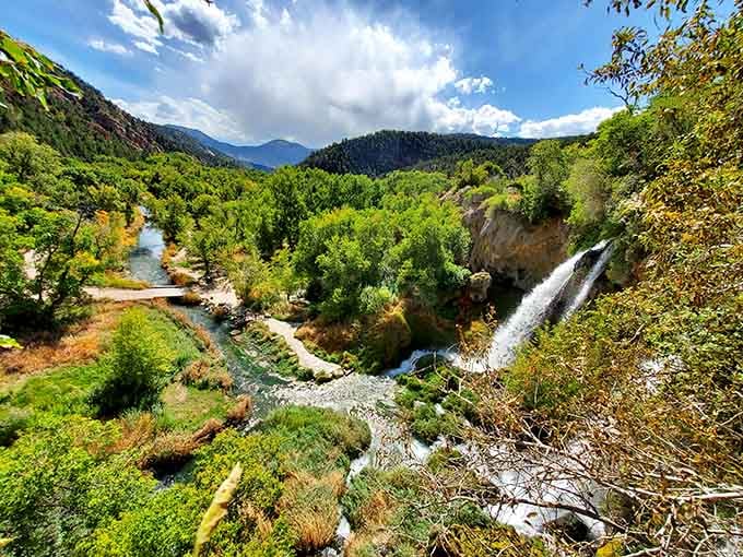 The falls tumble into emerald pools surrounded by lush vegetation, a hidden oasis that feels worlds away from everything.
