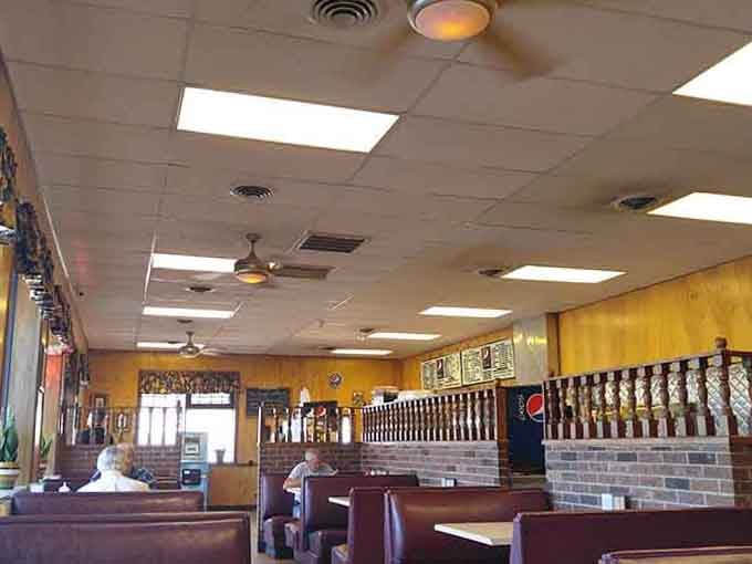 Warm wood paneling, spinning ceiling fans, and cozy burgundy booths make the Sunrise Drive-In feel like your favorite living room with a menu.