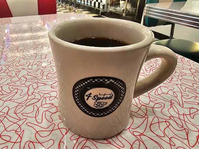 A sturdy diner mug wearing the 4 Speed logo like a badge of honor. Coffee tastes better with character.