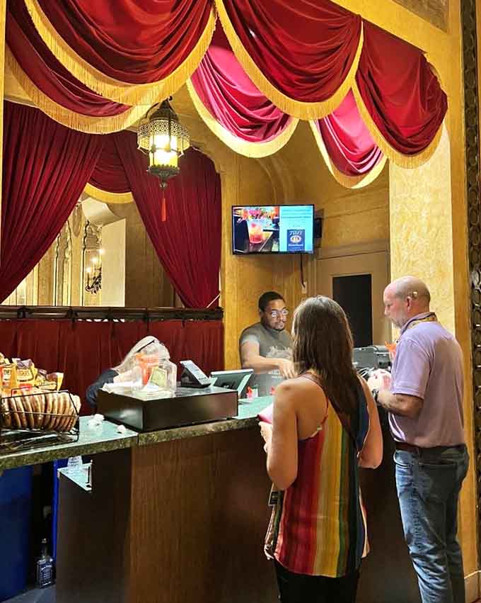 Even the concession stand comes draped in red velvet curtains, because at the Alabama Theatre, nothing gets left underdressed.