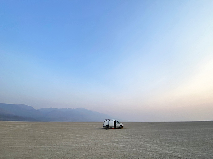 One lonely vehicle dots the vast expanse, looking like a toy car someone forgot in the world's largest sandbox.