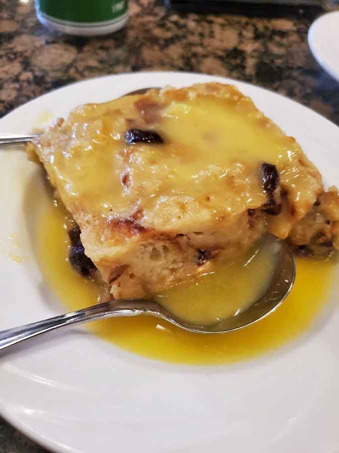 Bread pudding swimming in golden custard sauce. One spoonful and you'll understand why people save room for dessert here.