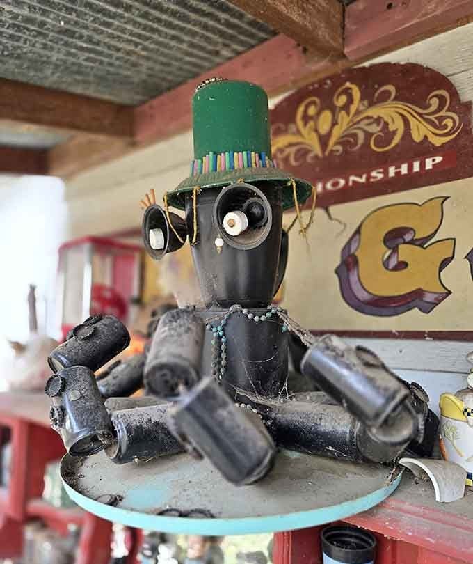 This little fellow, built entirely from salvaged parts, is wearing a green top hat and absolutely judging your life choices.