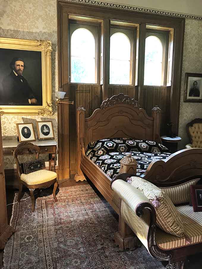 A bedroom frozen in time, where the portraits on the wall seem to know exactly who you are.