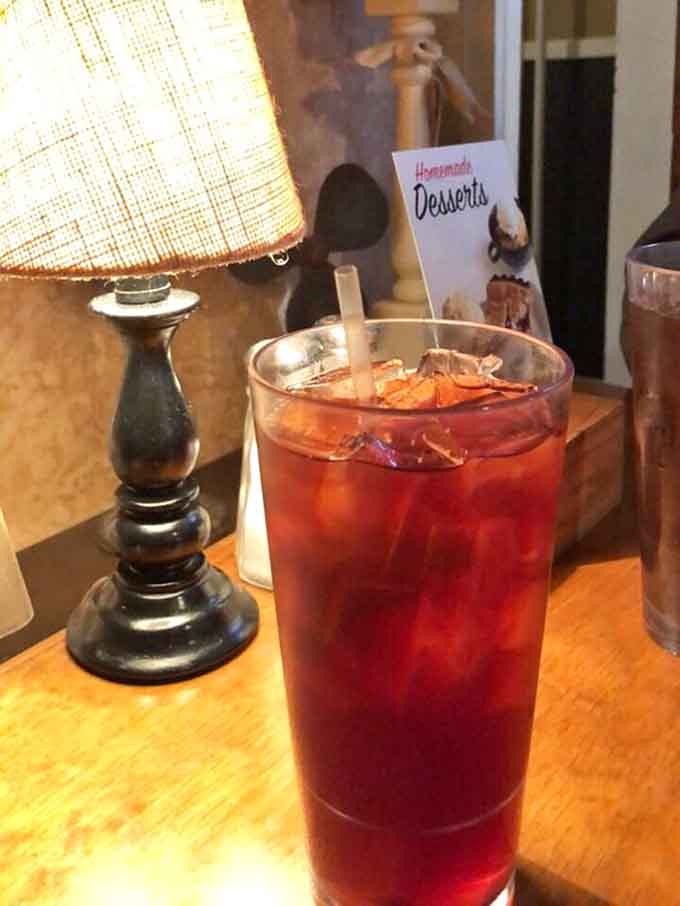 That deep red iced tea glowing under the lamp light, with a homemade desserts menu peeking in. Perfect pairing.