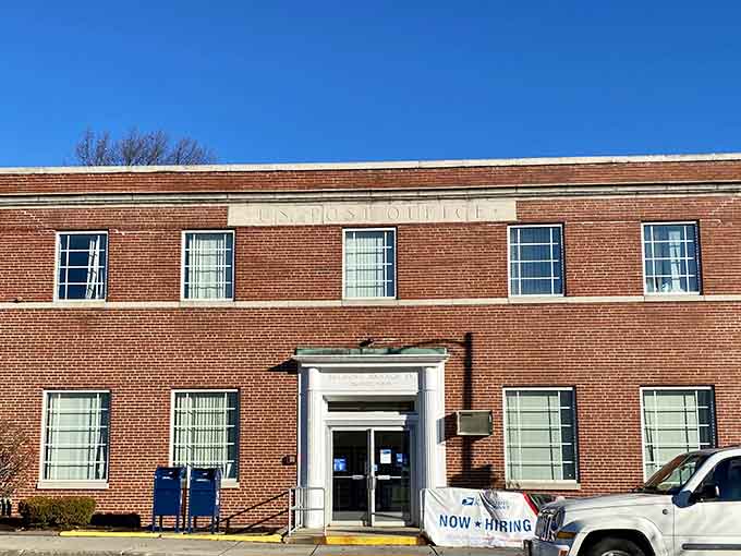 Classic brick post office building where people still mail actual letters and know their postal workers by name.