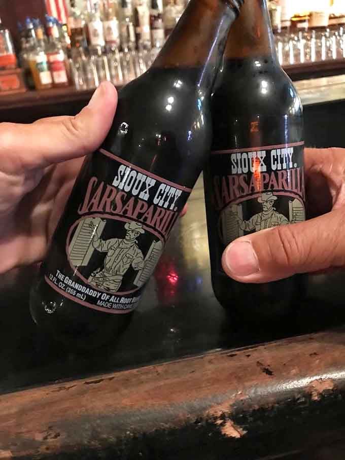 Clinking Sioux City Sarsaparilla bottles at a historic Tombstone bar feels exactly as satisfying as it looks.