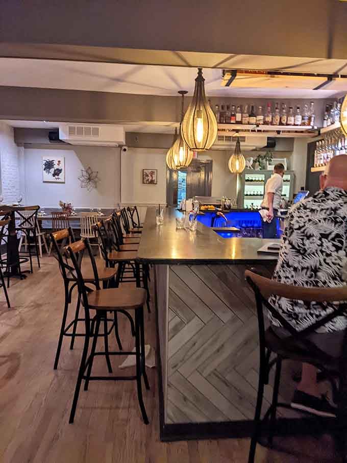 Warm pendant lights, a well-stocked bar, and good energy. The kind of bar area where you happily lose track of time.
