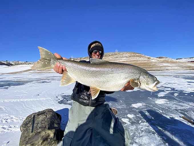 That smile says everything. Ice fishing at Blue Mesa Reservoir produces some genuinely impressive catches.