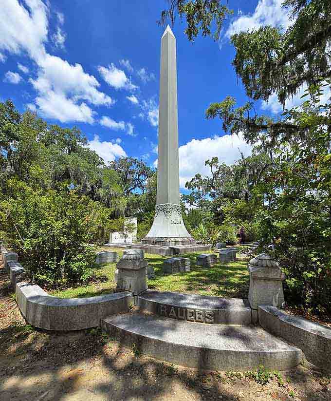 The Rauers obelisk punches straight through the tree canopy like it has somewhere very important to be.