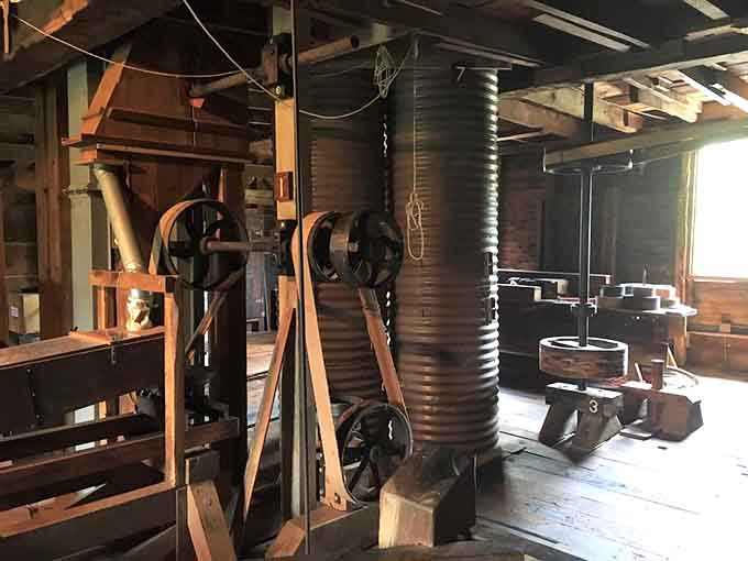 Inside the mill, belts, wheels, and wooden beams hum with purpose. History here isn't behind glass. It's still working.