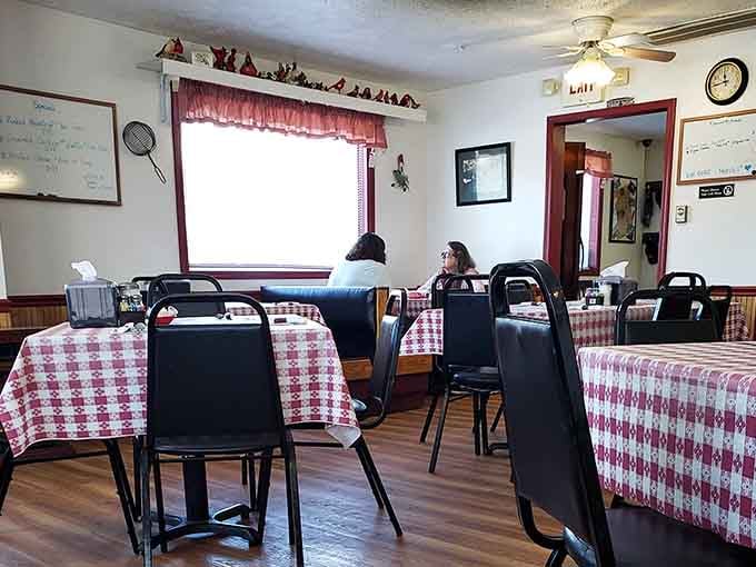 Two diners settled into a checkered booth, the specials board behind them, the whole room quietly humming with easy contentment.