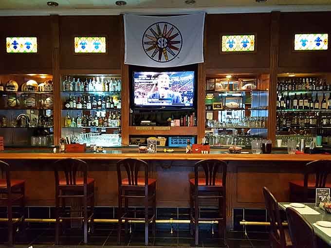 The bar at the Bright Star is warm, well-stocked, and proudly flying the SEC flag, because priorities matter in Alabama.