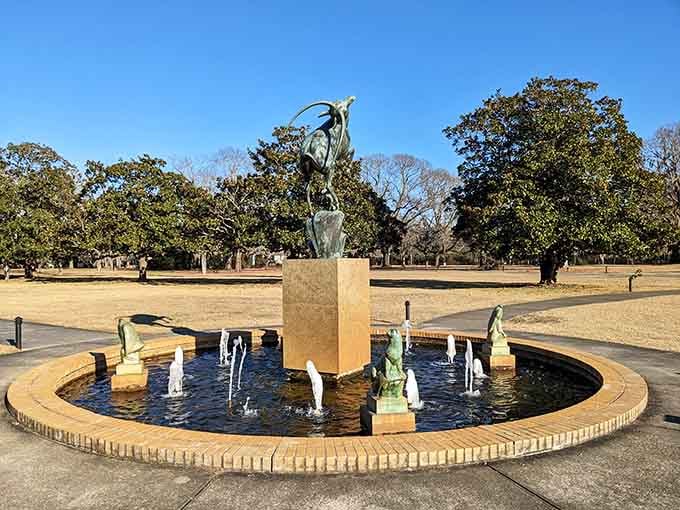 The Leaping Gazelle fountain brings graceful movement to still bronze, surrounded by smaller sculptures creating aquatic choreography.