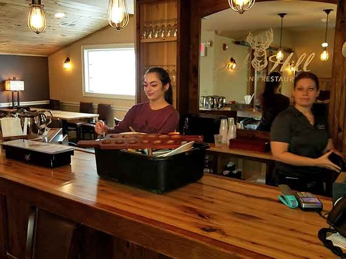 Friendly faces behind a polished wood bar — the kind of staff that makes you feel like a regular on visit one.