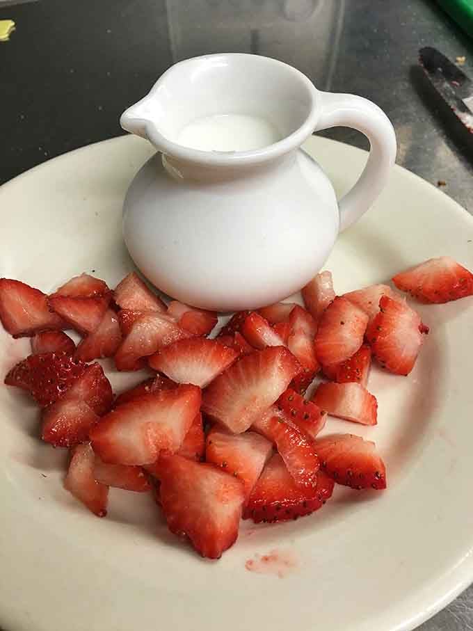 Fresh strawberries with cream on the side, simple, bright, and exactly the kind of detail that separates good from great.