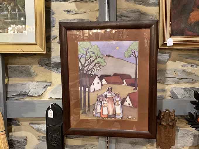 Folk art framed in dark wood, the kind of painting that makes a blank wall jealous.