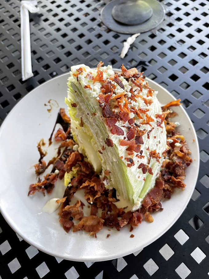 The wedge salad stands tall and proud, loaded with bacon because vegetables need proper moral support.
