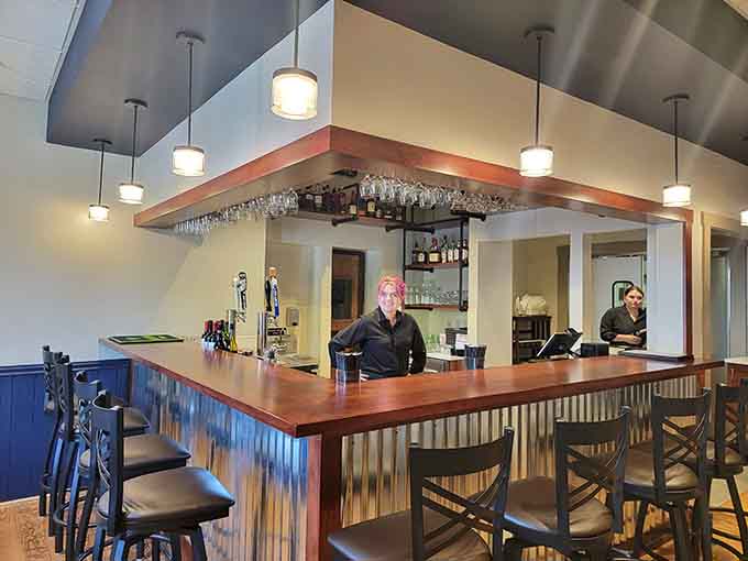 The bar area combines modern lighting with classic warmth, creating the perfect spot for pre-dinner drinks or post-meal celebrations.
