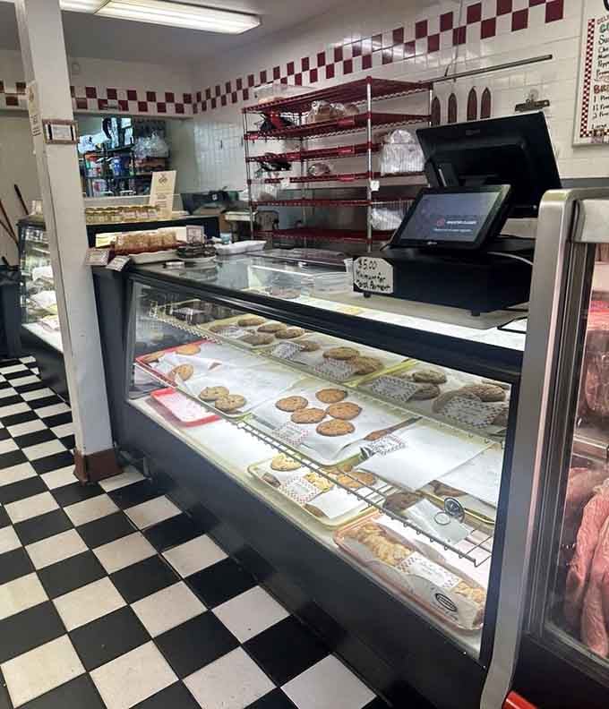 The bakery counter at Cecil's, where fresh cookies and baked goods sit under glass on a cheerful black-and-white tile floor.