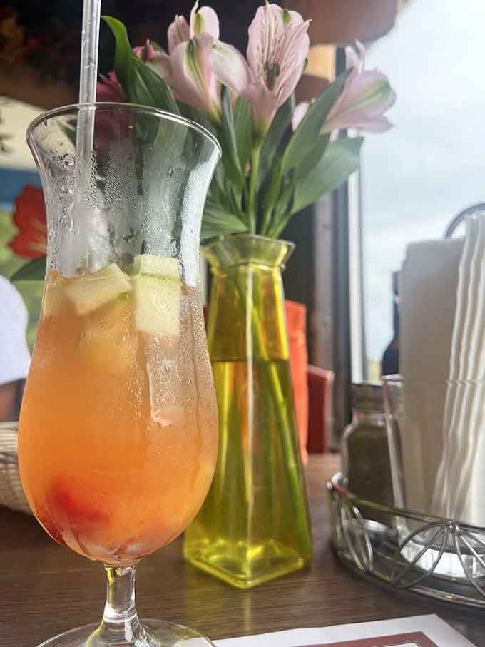 A cold, colorful cocktail with flowers nearby. Somehow, this drink makes everything feel like a celebration.