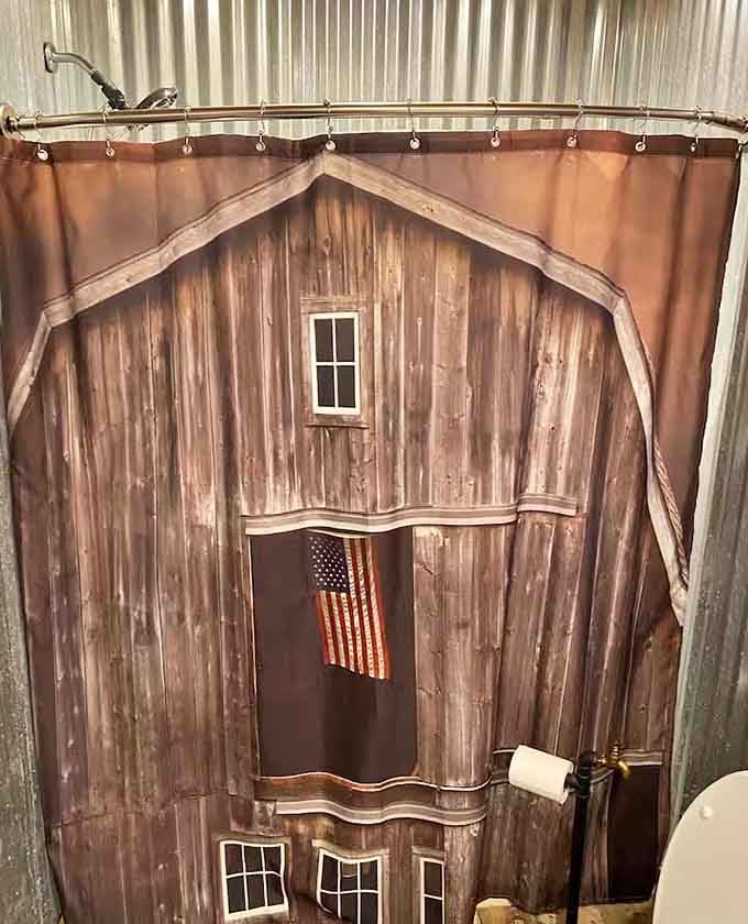 Even the shower curtain commits to the Western theme. A barn and an American flag. Naturally.