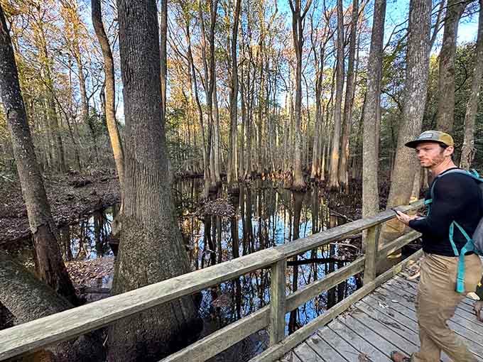 One visitor pauses on the boardwalk, phone in hand, clearly reconsidering every vacation he's ever taken before.