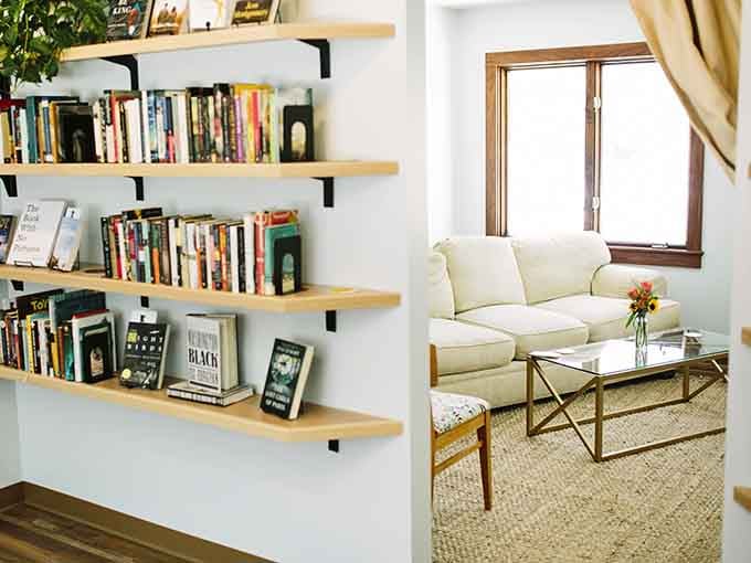 A cozy sofa, shelves of books, and a window letting in just enough light. This little nook is basically a hug in room form.