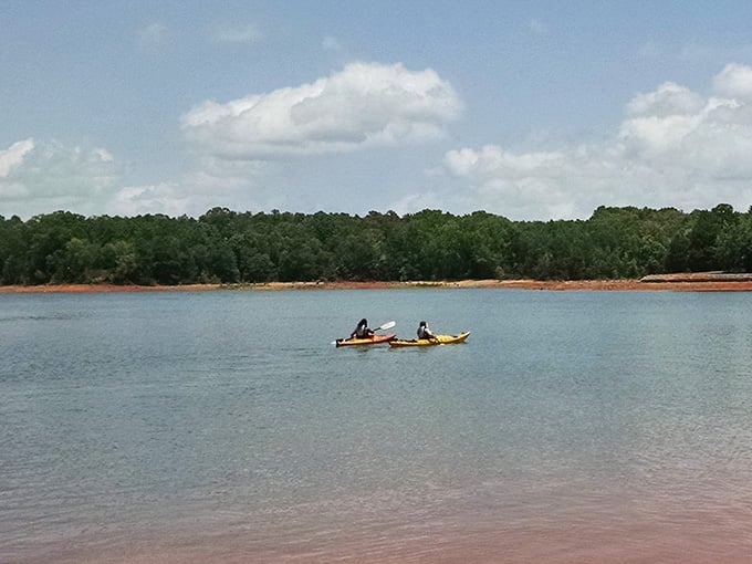 Kayakers gliding across calm waters, living their best life without a traffic jam in sight.