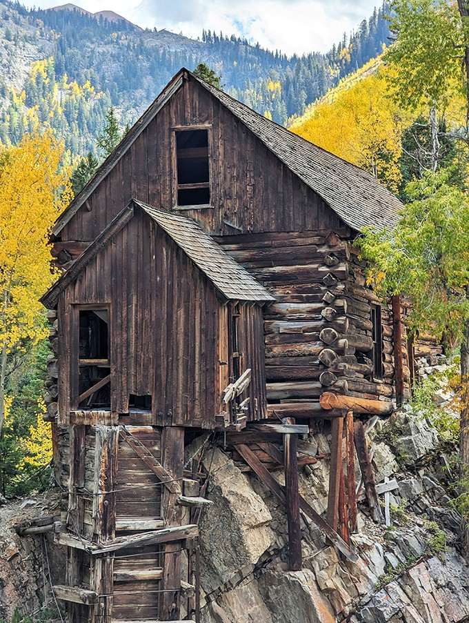 Weathered wood and empty windows tell stories of miners who once depended on this remarkable structure.