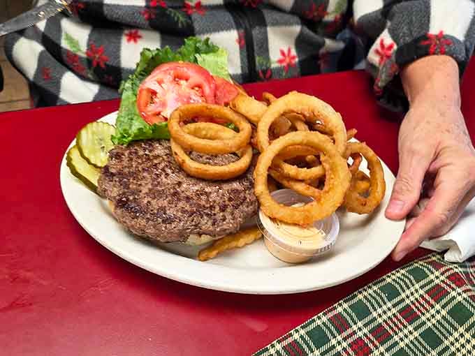 A thick, honest burger with golden onion rings. No fuss, no foam, just a plate that delivers every time.