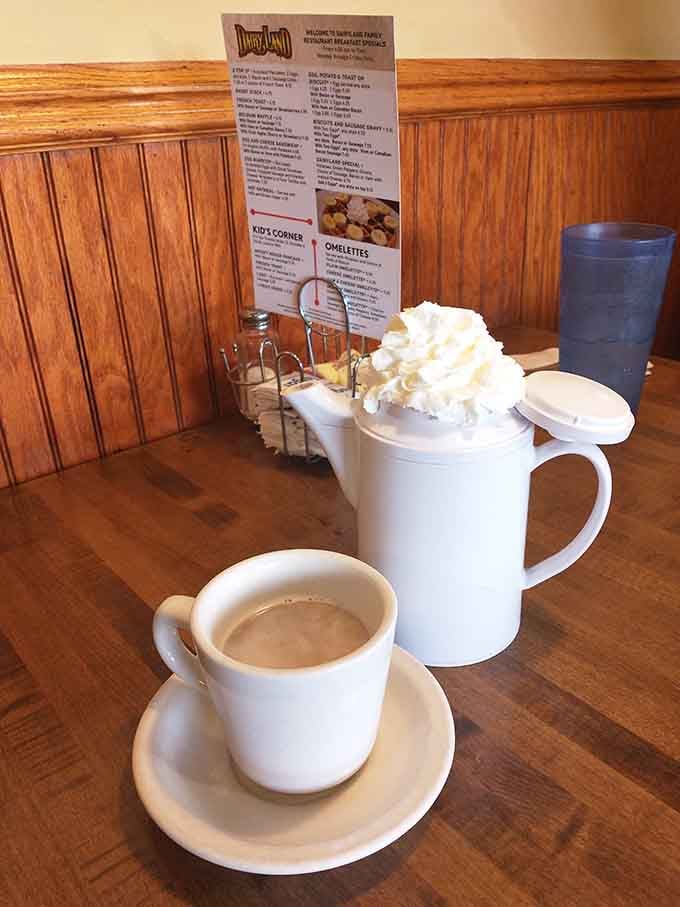 Coffee and a menu on a quiet wooden table, the universal setup for a perfect morning decision.