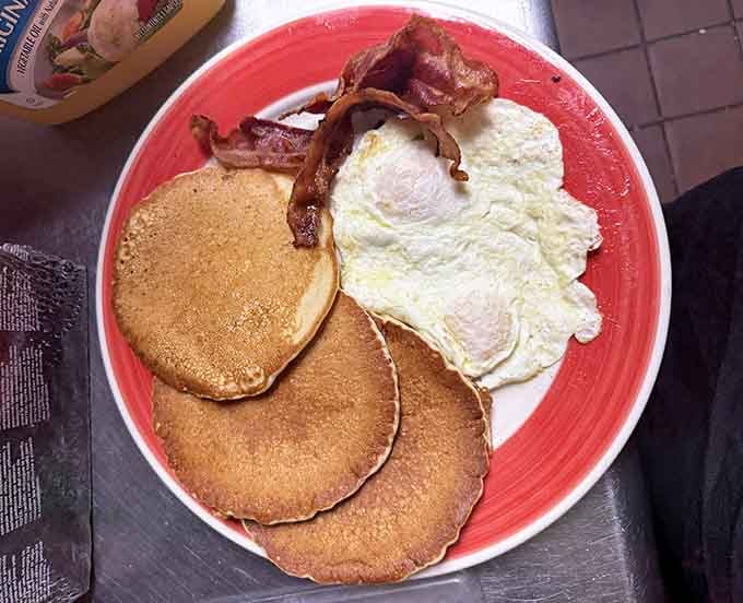 Fluffy pancakes, crispy bacon, and sunny-side-up eggs. This breakfast plate is the kind of morning that makes you forget what day it is.