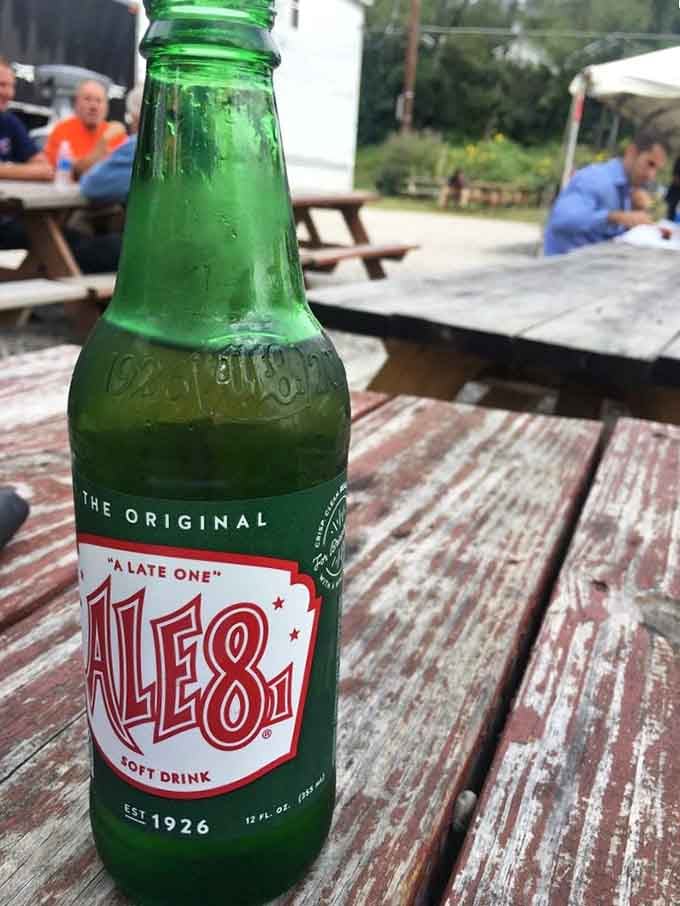 An Ale-8-One bottle sweating on a picnic table, this Kentucky-born ginger soda has been the perfect BBQ sidekick since 1926.